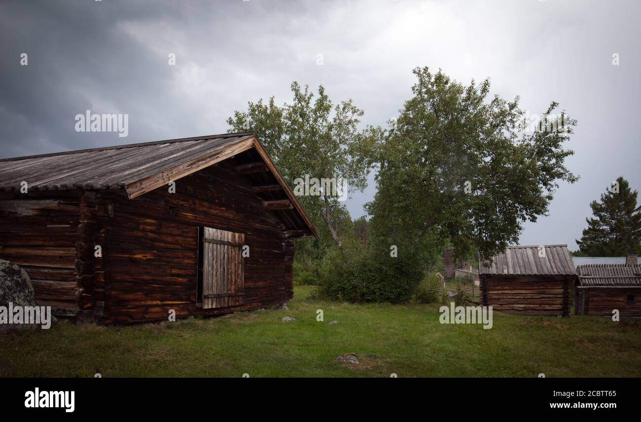 Wooden warehouse, storehouse, farmhouse far out in rural country. Trees ...
