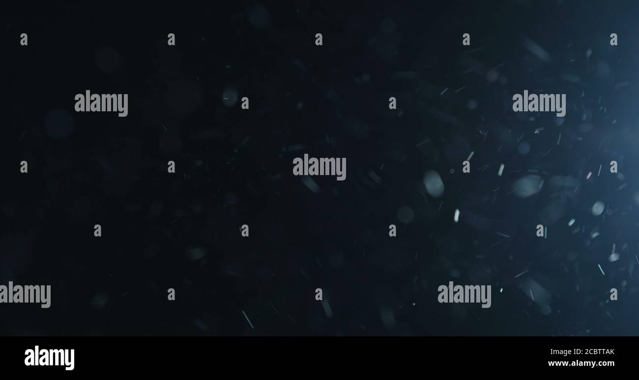 natural dust particles flow in air on black background, wide photo ...