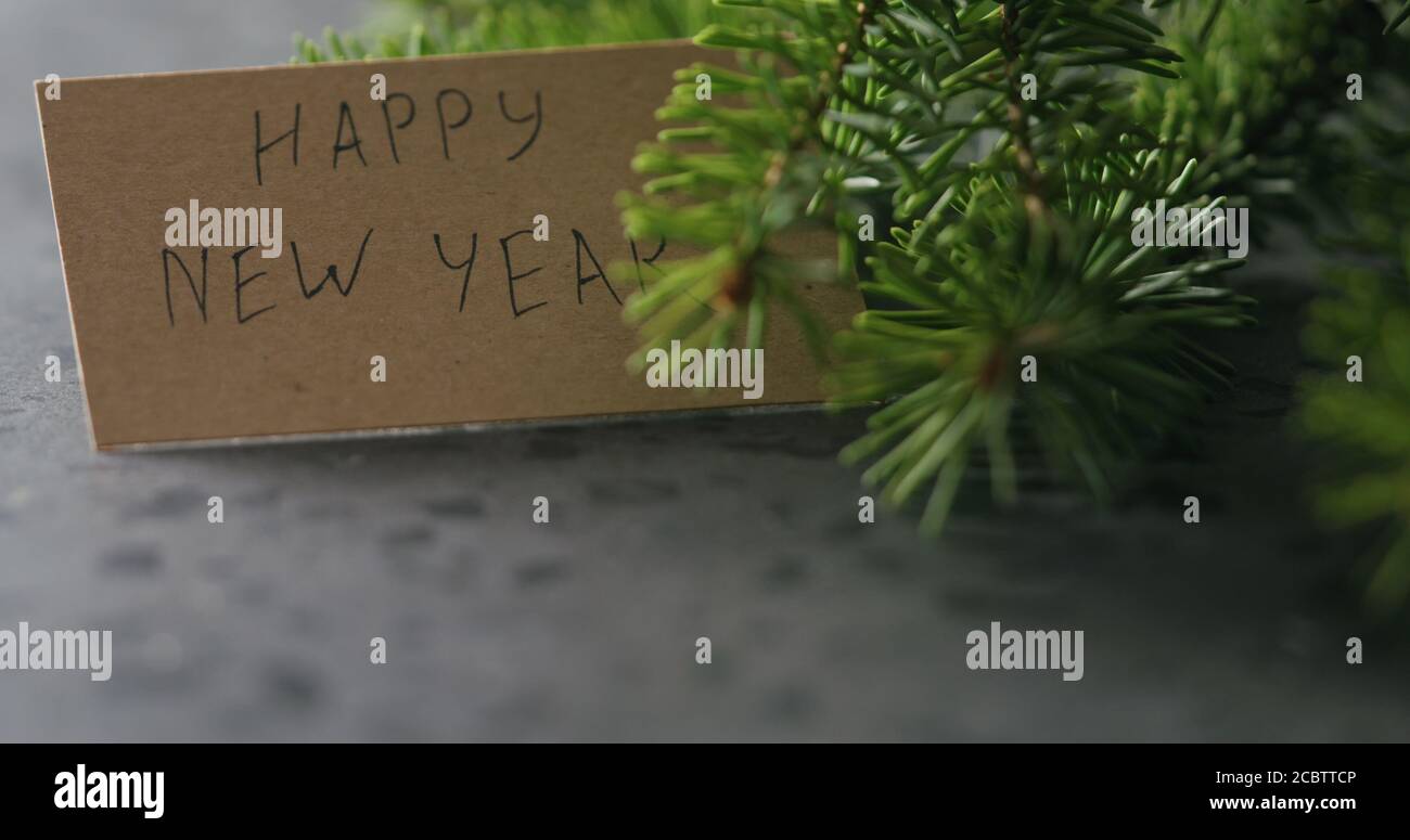 happy new year card next to spruce twig, wide photo Stock Photo - Alamy