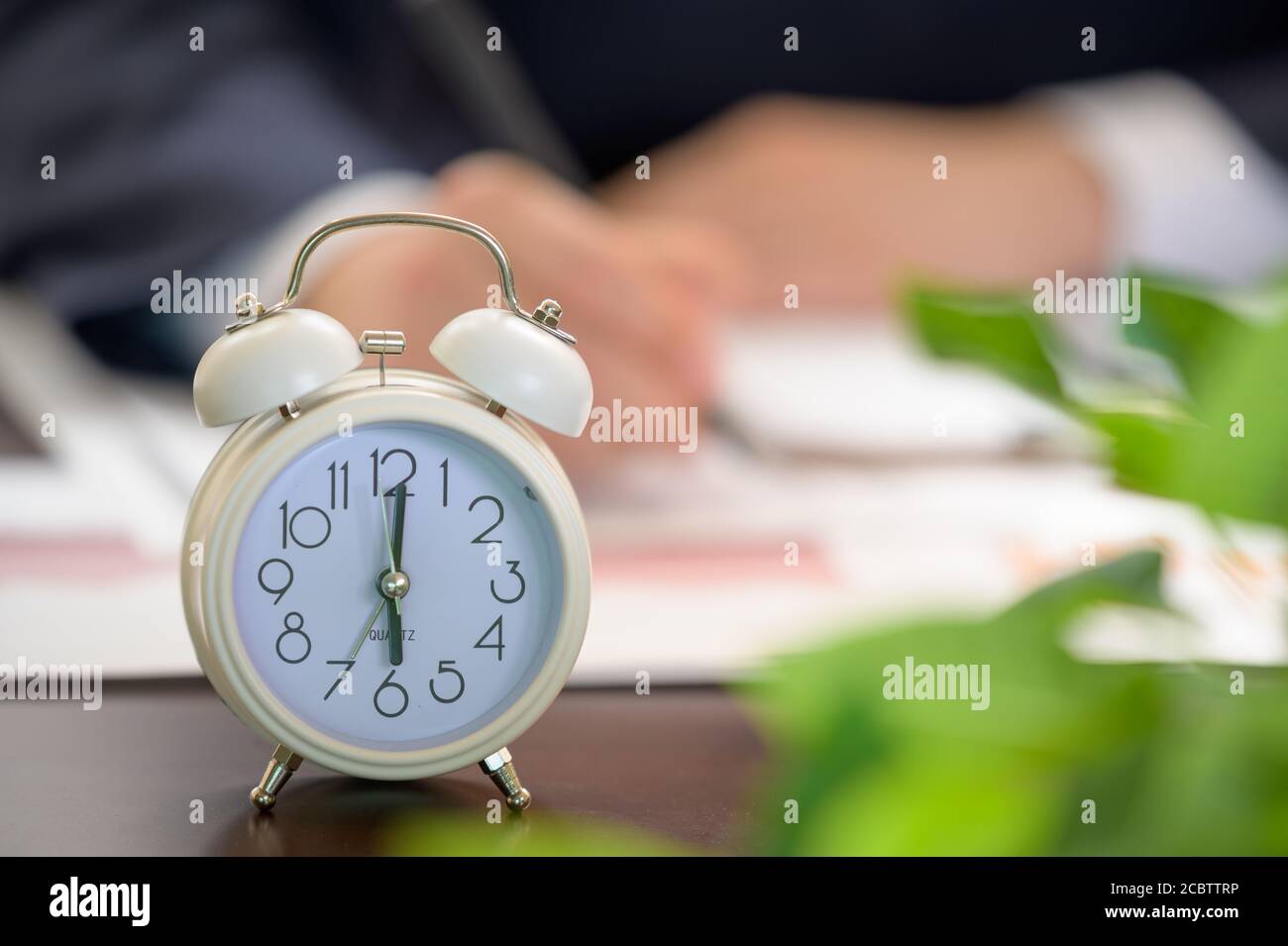 Working Businessman and White Alarm Clock. Work Time concept Stock ...