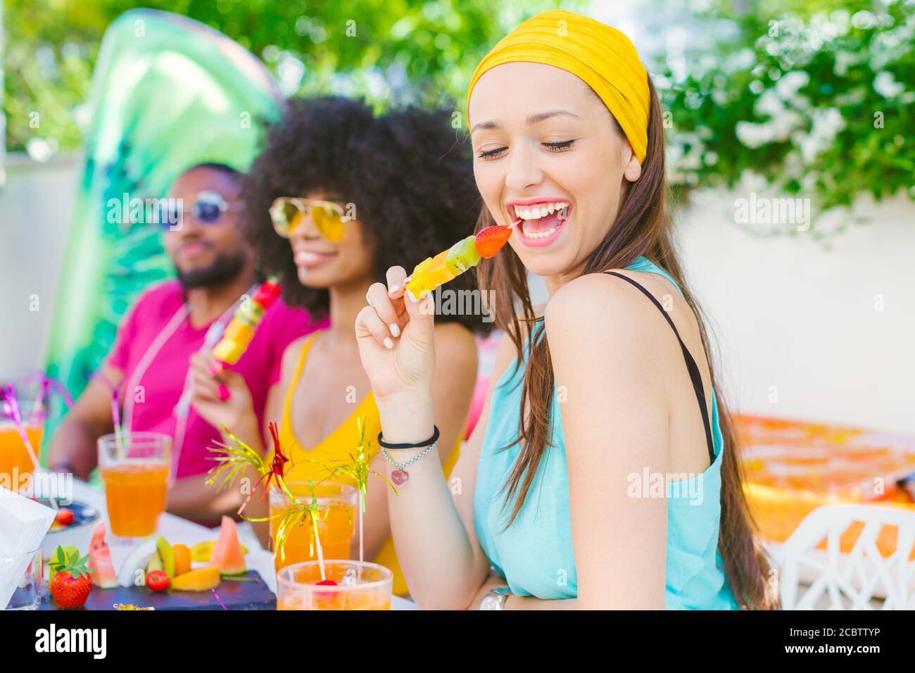 Mixed race group of friends having fun -millennials eating and drinking ...