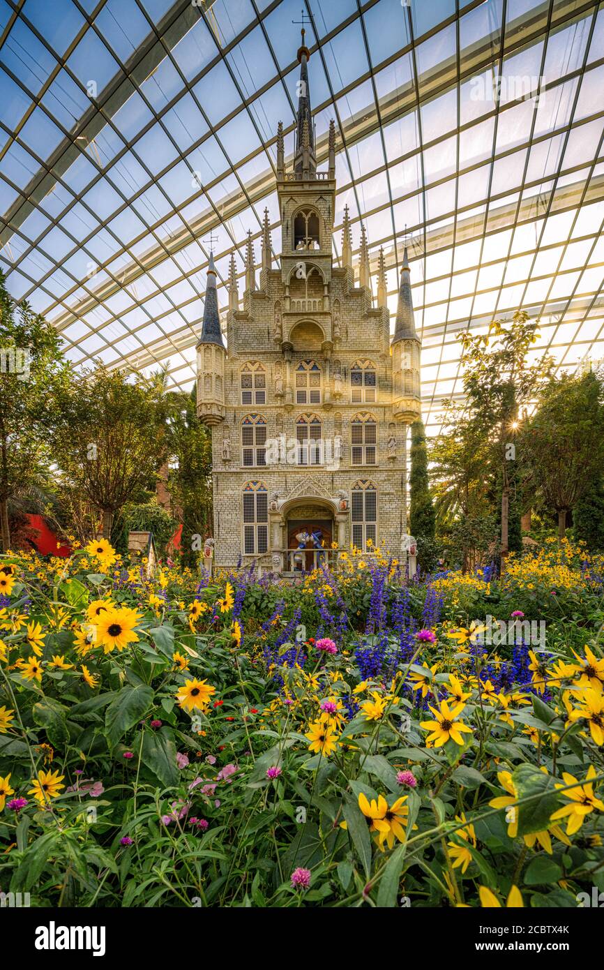 European church facade among flowers and fauna inside the flower dome ...