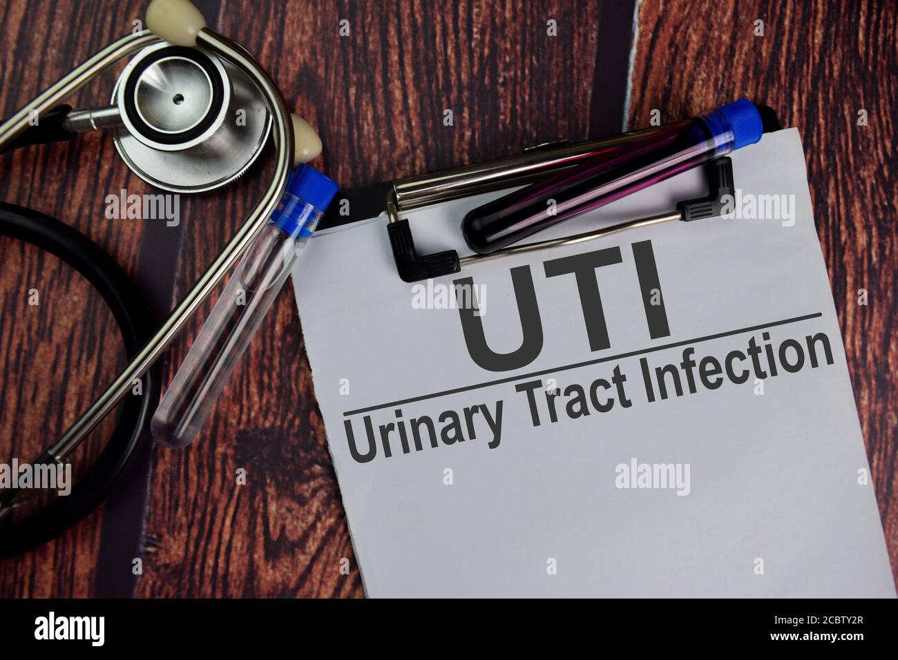 UTI - Urinary Tract Infection text write on a paperwork isolated on ...