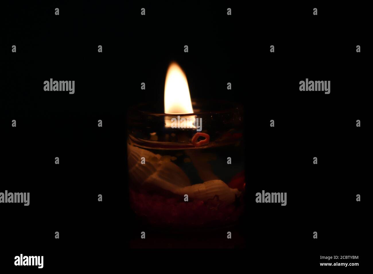 Flame of a colorful candle on dark background in low light Stock Photo ...