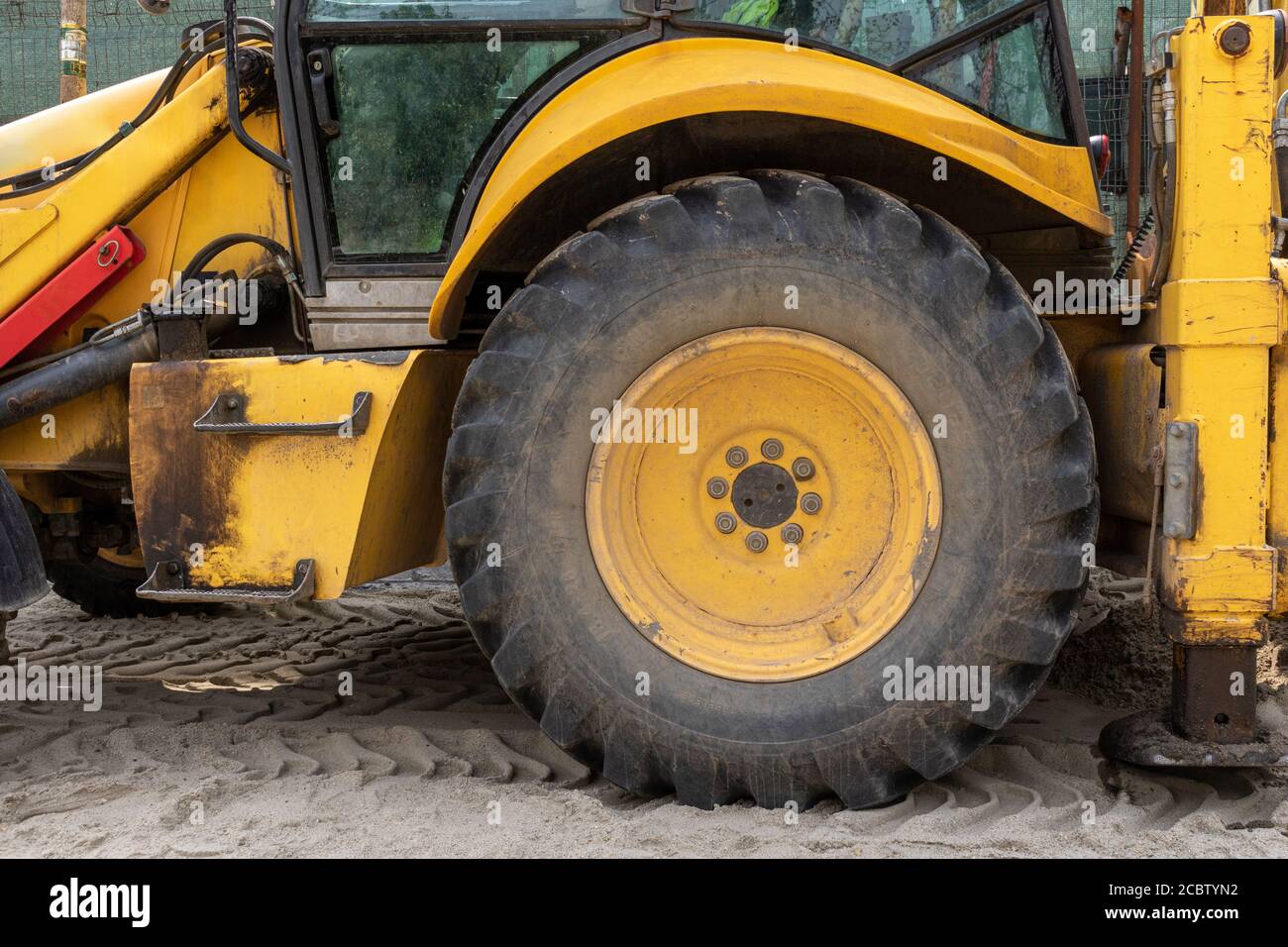 Giant wheels of the yellow bulldozer Stock Photo - Alamy