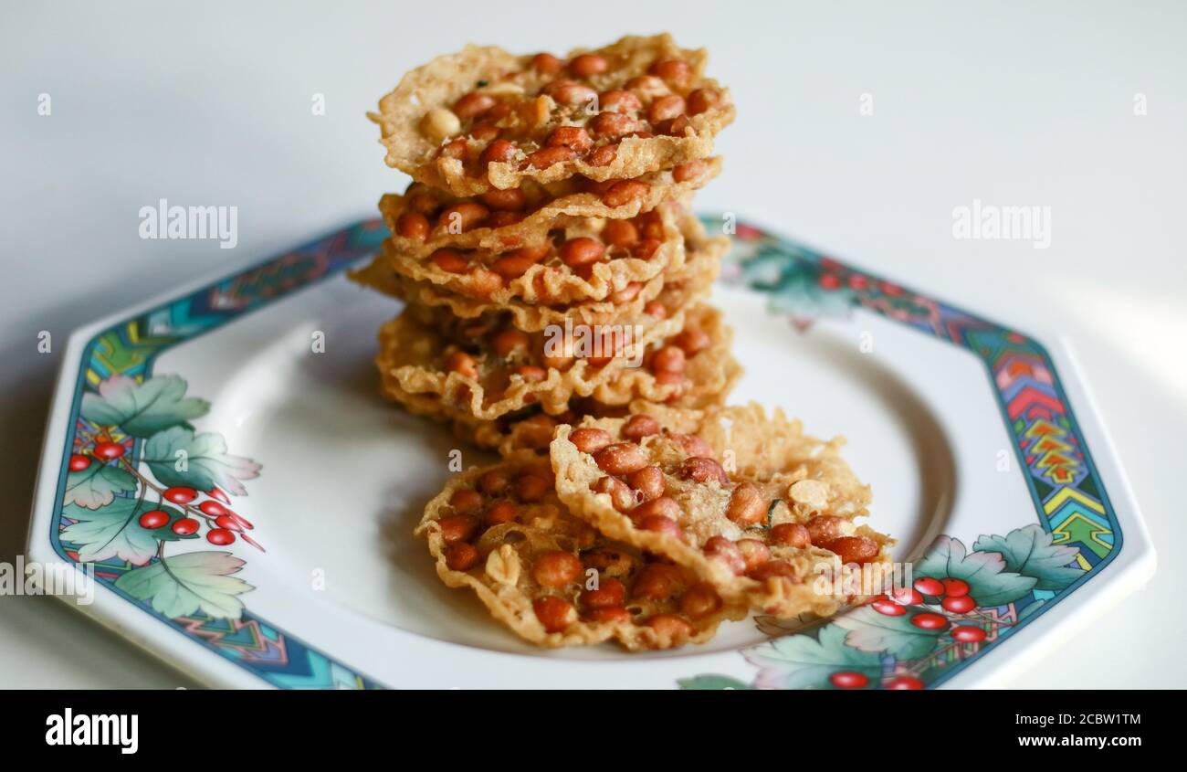 Peanut Peyek on plate. Peanut Rempeyek or Peyek is a deep-fried savoury ...