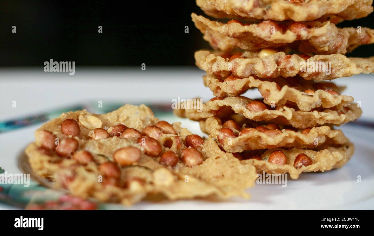 Peanut Peyek on plate. Peanut Rempeyek or Peyek is a deep-fried savoury ...