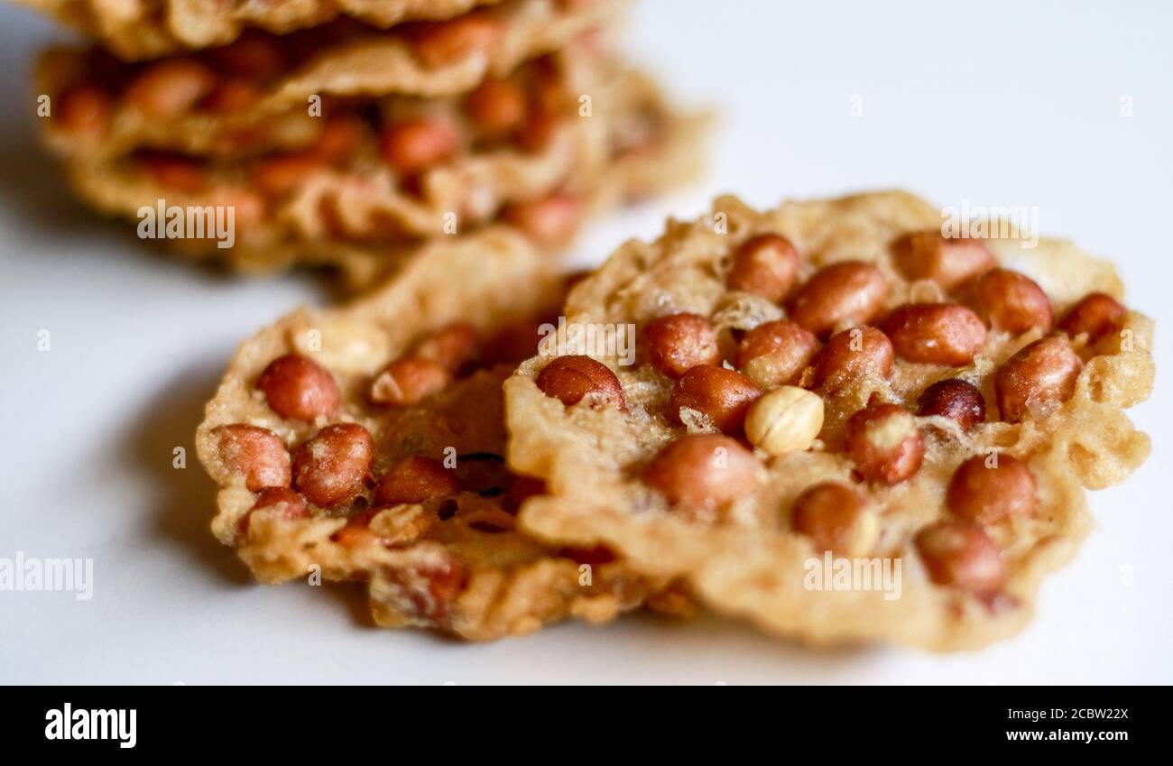 Peanut Peyek on white background. Peanut Rempeyek or Peyek is a deep ...