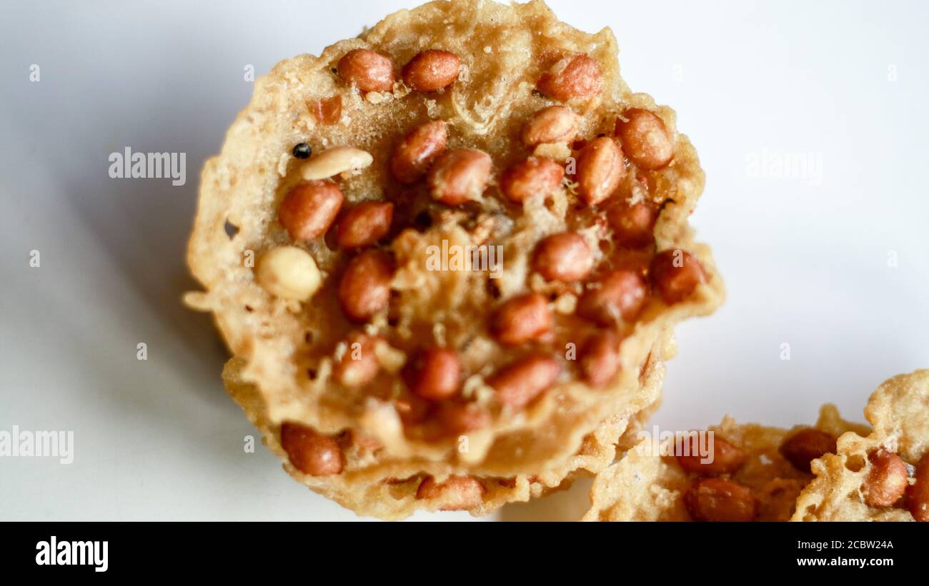 Peanut Peyek on white background. Peanut Rempeyek or Peyek is a deep ...