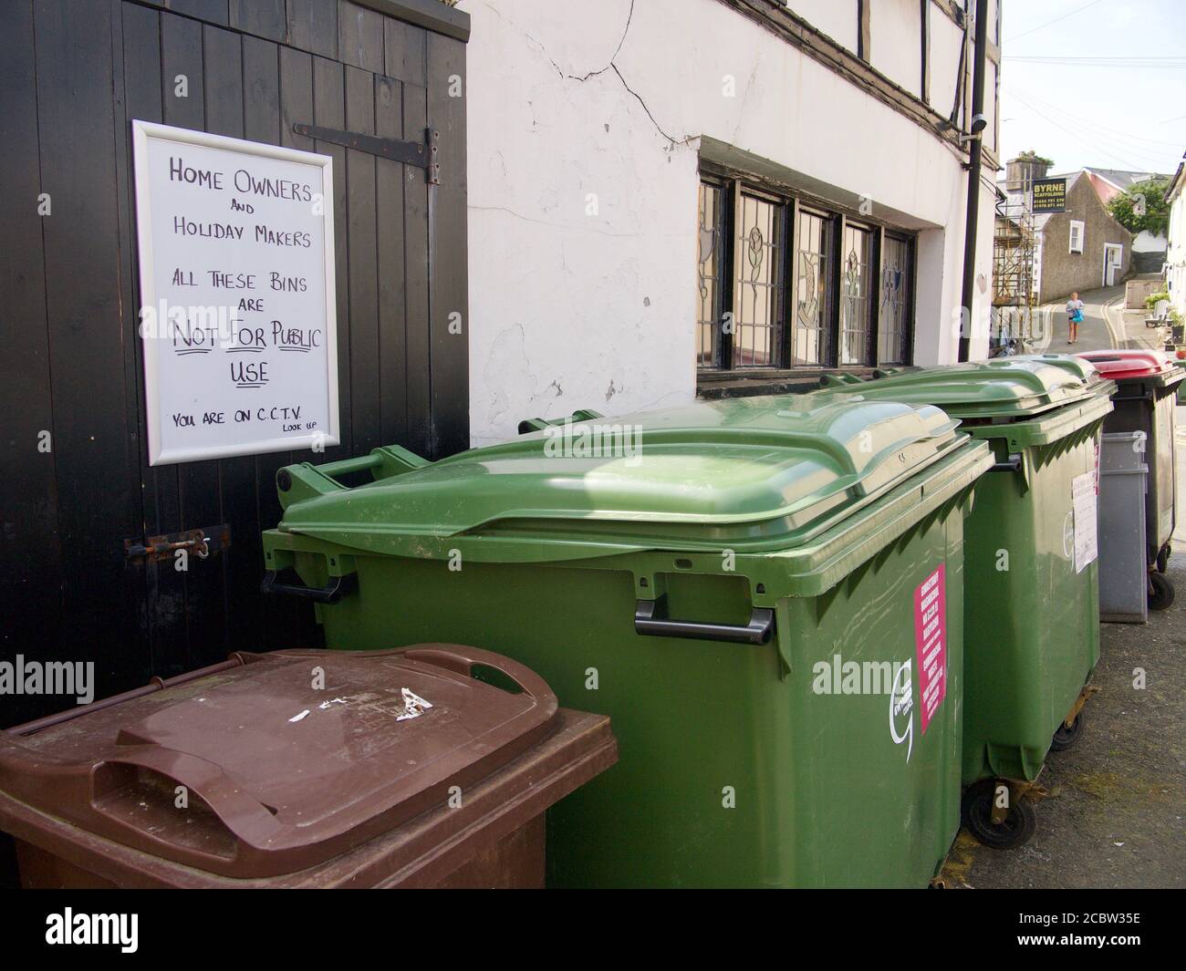 Rubbish bins with warning notice, Aberdovey, Wales Stock Photo - Alamy