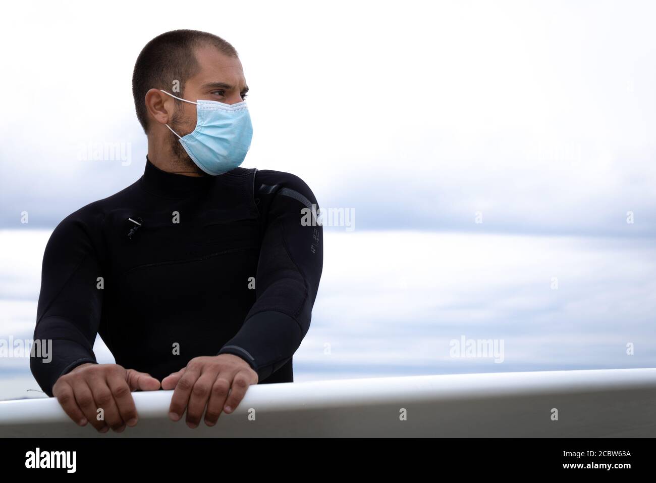 Surfboard Surfer, Man in Mask and Wetsuit on the Beach Stock Photo - Alamy