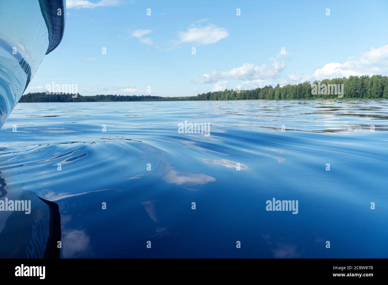 Side view Speeding fishing motor boat with drops of water. Blue ocean ...