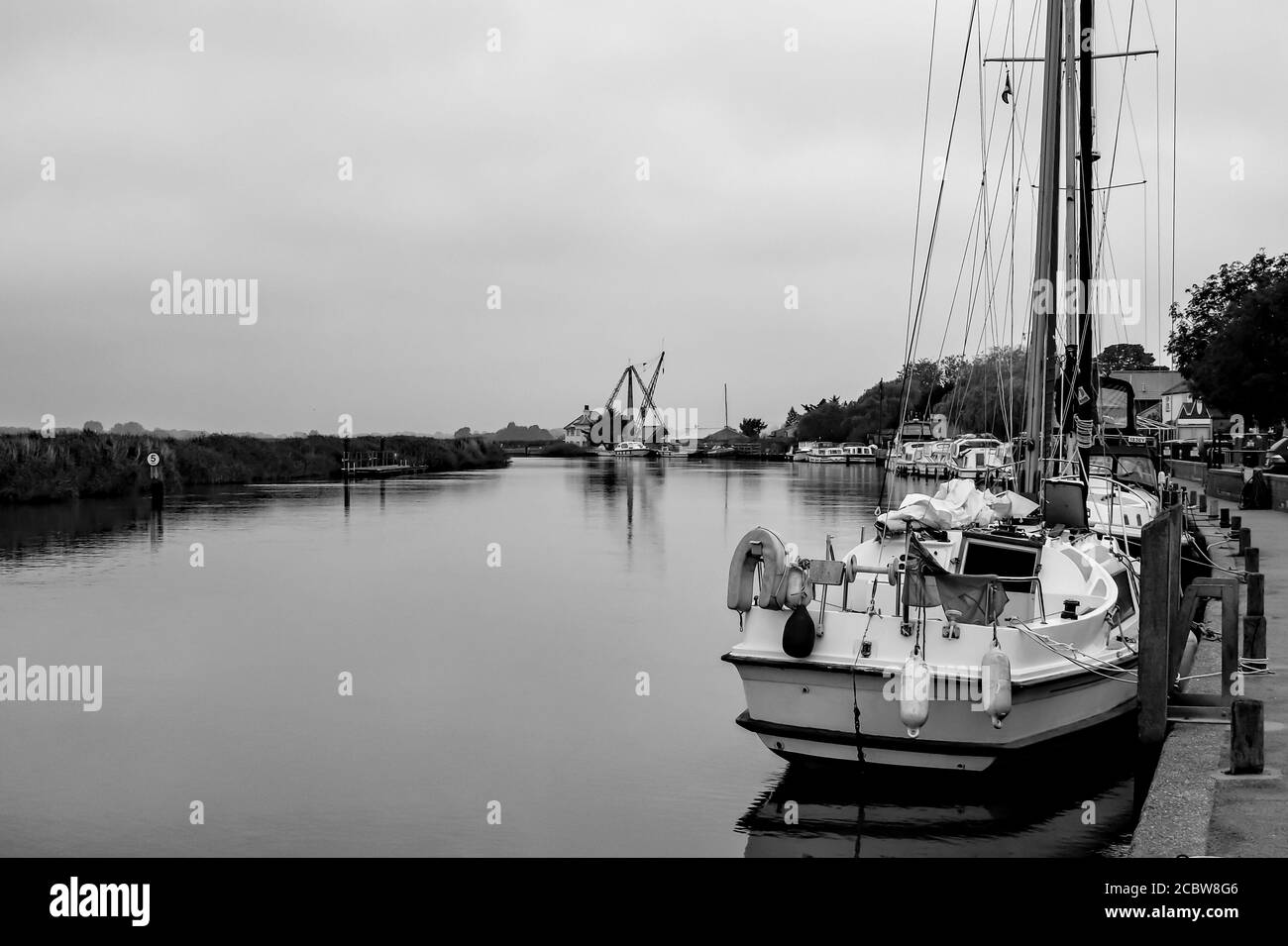 A view along the quayside and the River Yare in the village of Reedham ...