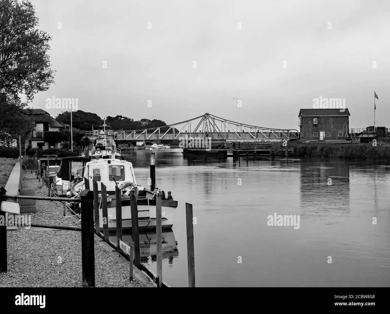 Black and white pohot of a view down the River Yare towards the metal ...