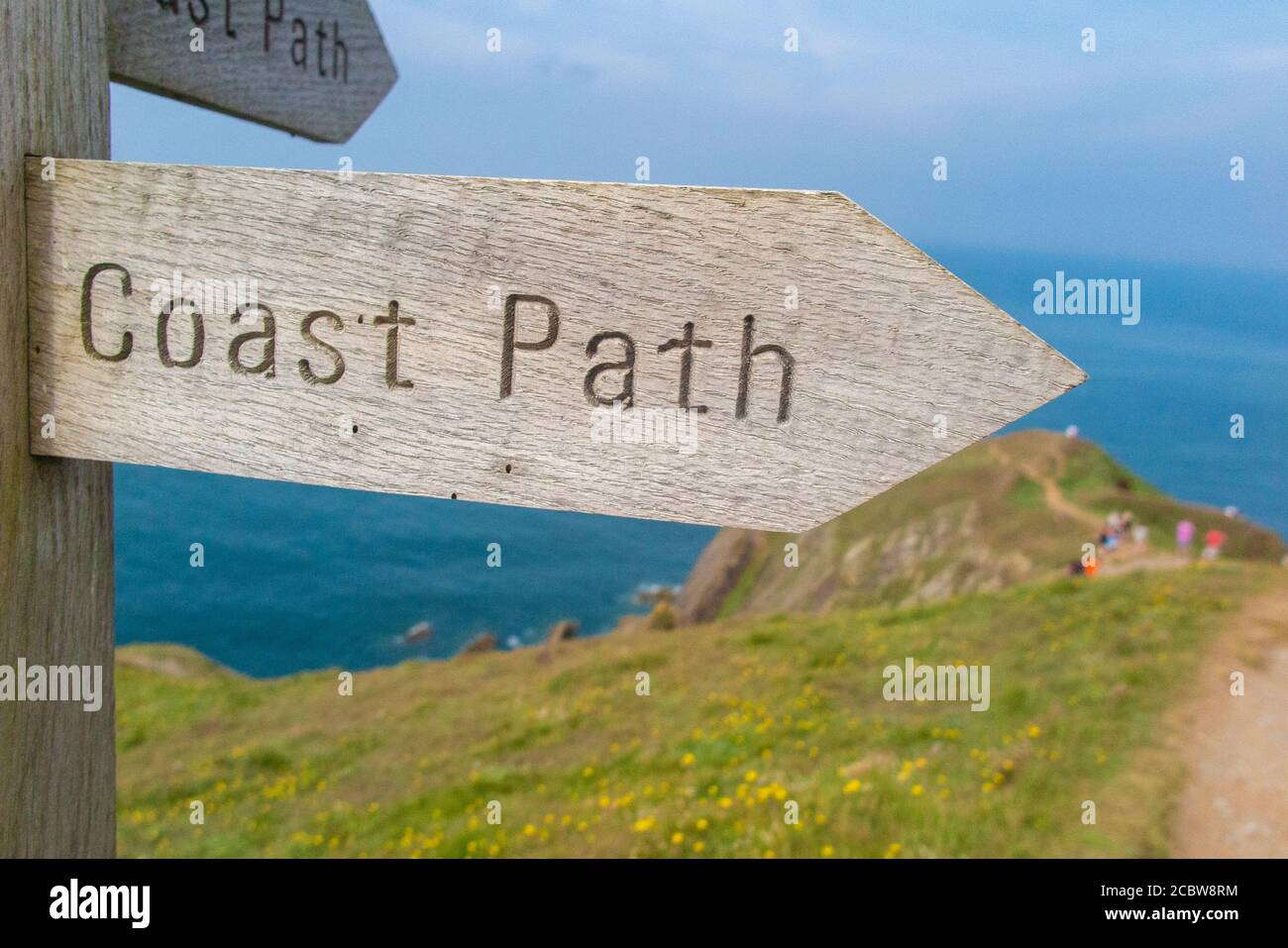 A wooden coastal path sign at Baggy Point in North Devon, England ...