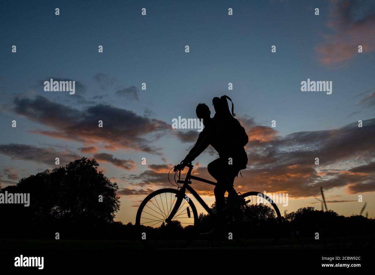 Man cycling through fields hi-res stock photography and images - Alamy