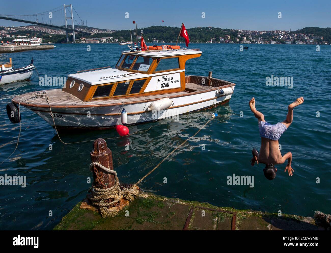 Boy jumping boat hi-res stock photography and images - Alamy