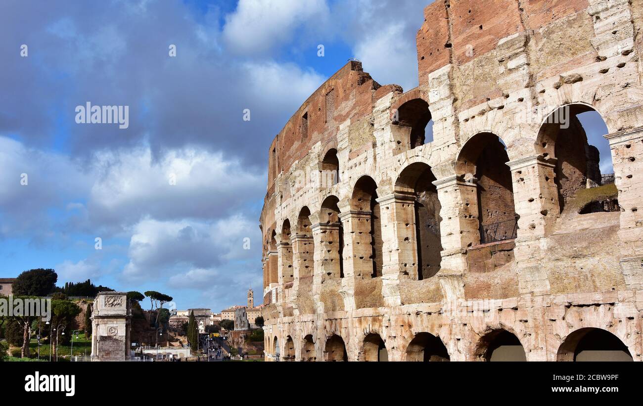Coliseum and roman archeological area with cloudy sky Stock Photo - Alamy