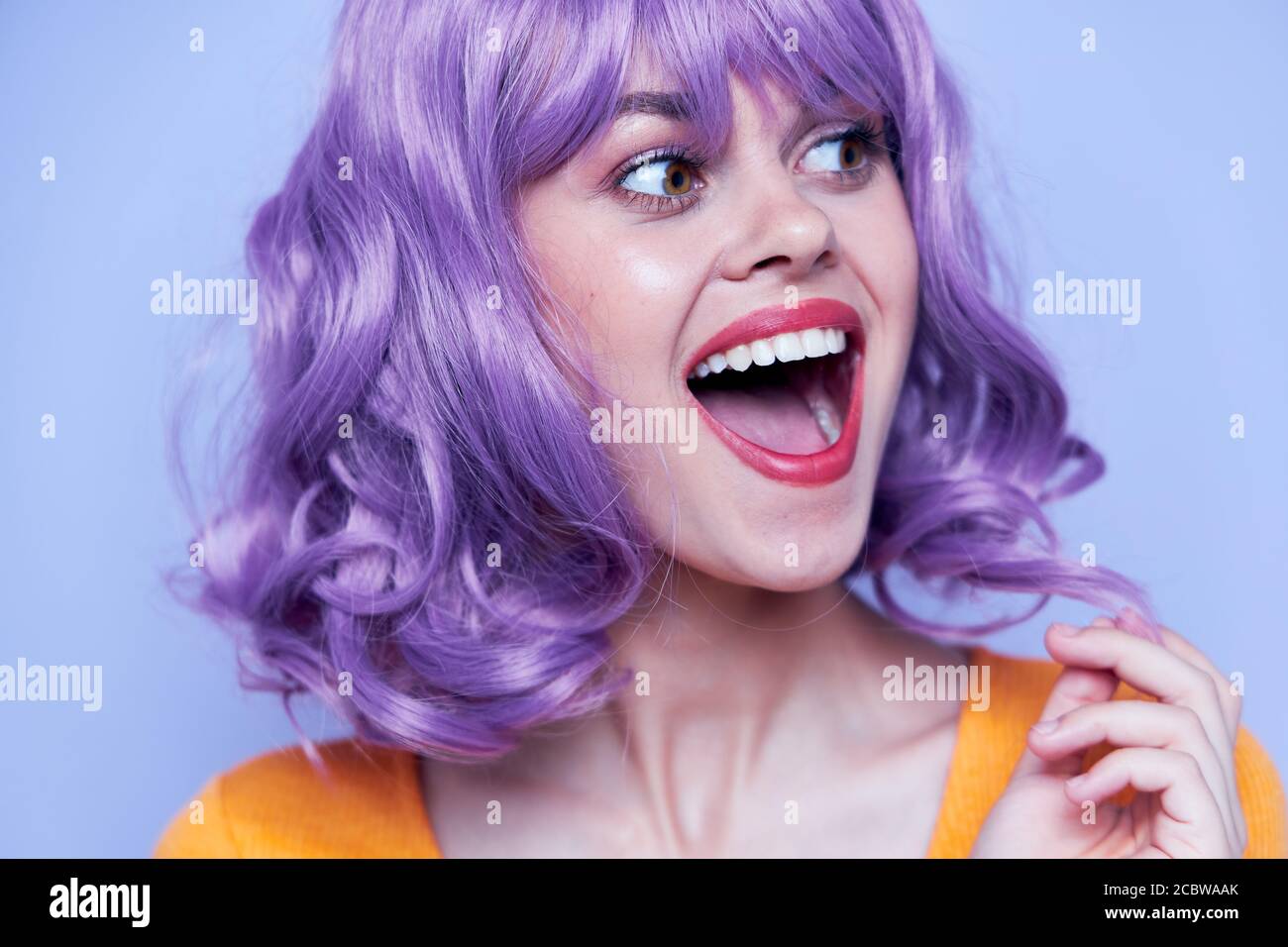 Attractive and smiling model purple hair disco Stock Photo - Alamy