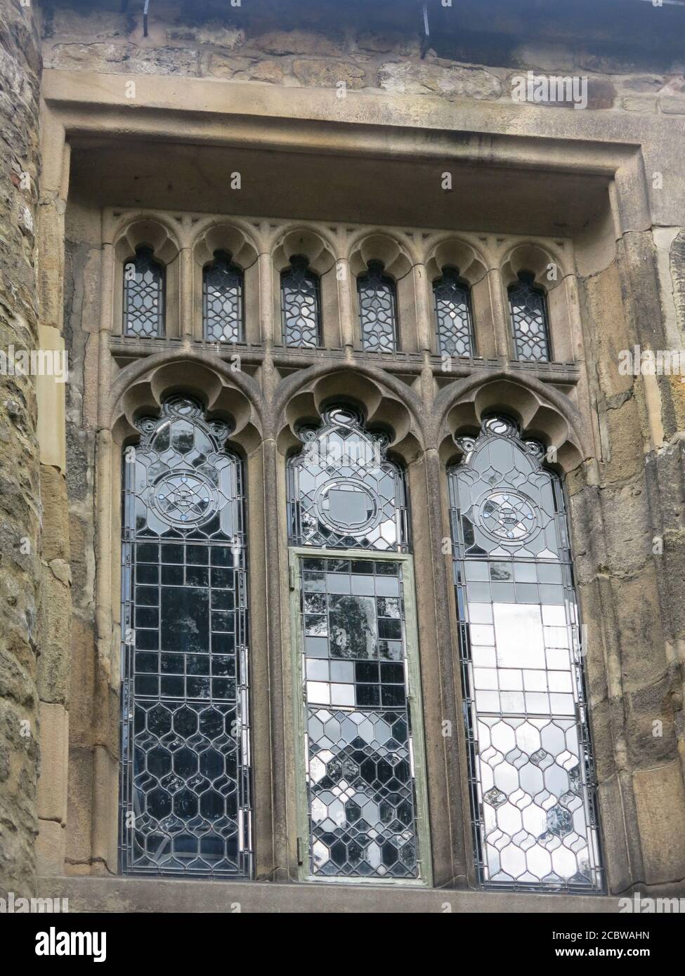 Tall arched windows in the ancient walls of Whalley Abbey, part of the ...