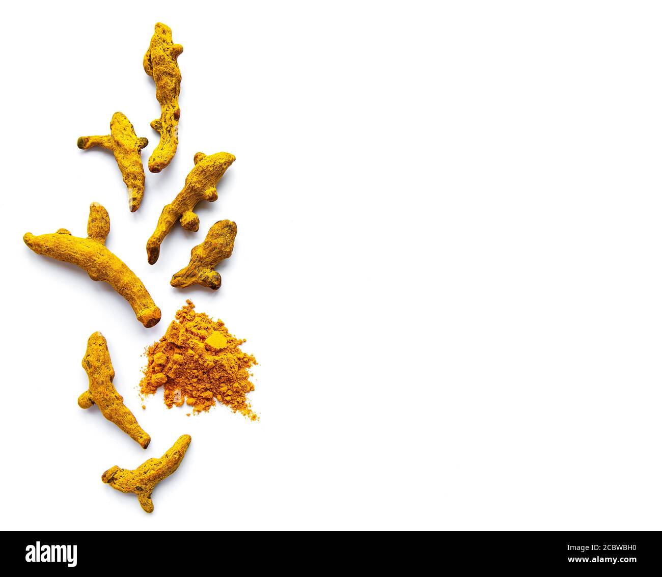 Yellow turmeric powder and dry roots on white background Stock Photo ...
