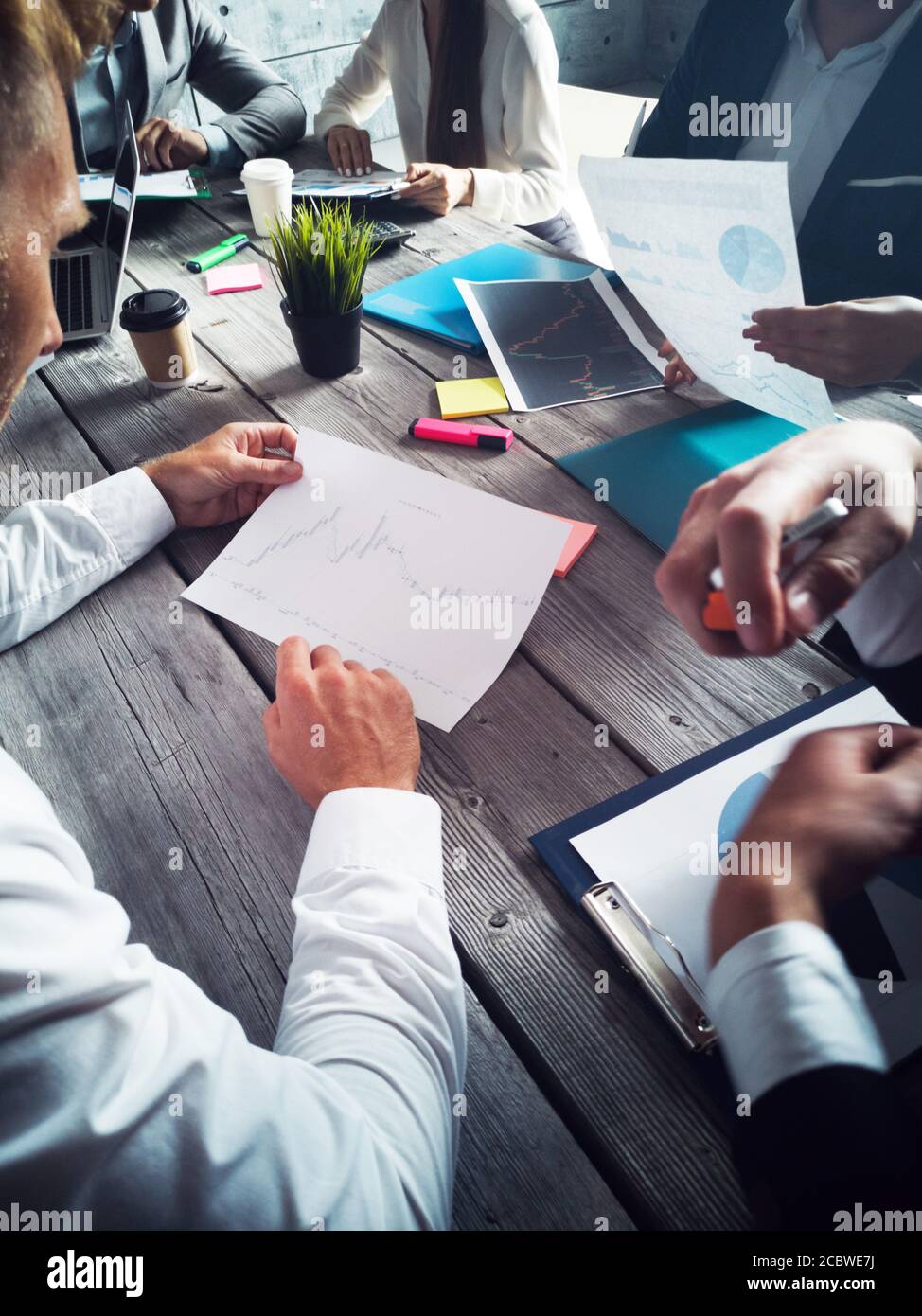 Business people analyzing data diagrams financial reports development ...