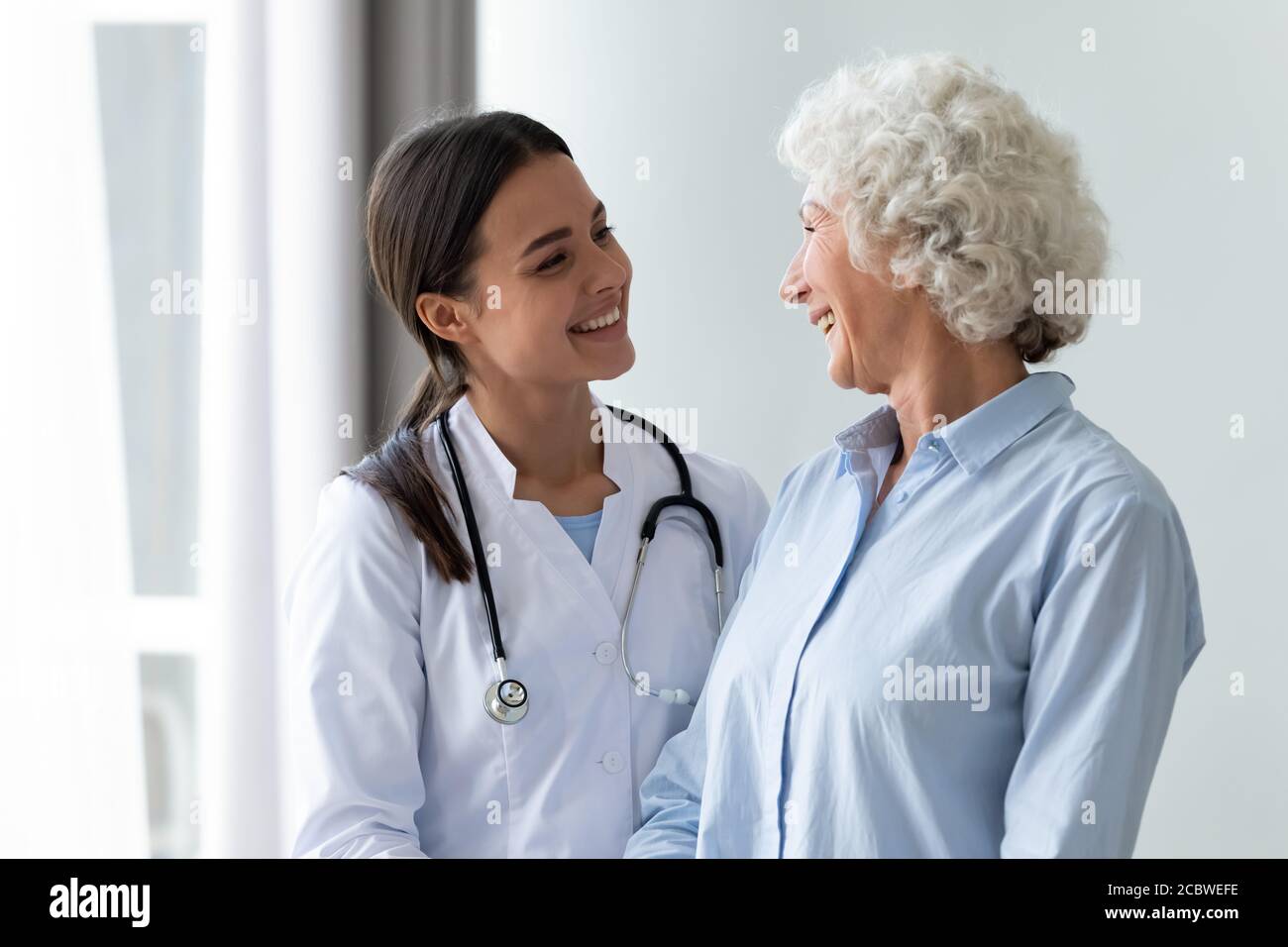 Caring millennial nurse helping middle aged patient at meeting Stock ...