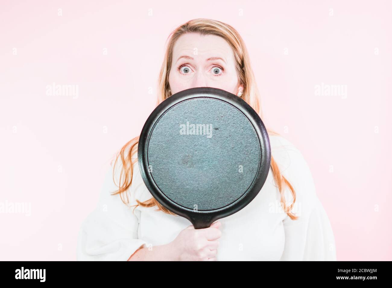 Studio portrait of middle aged business woman with frying pan Stock ...