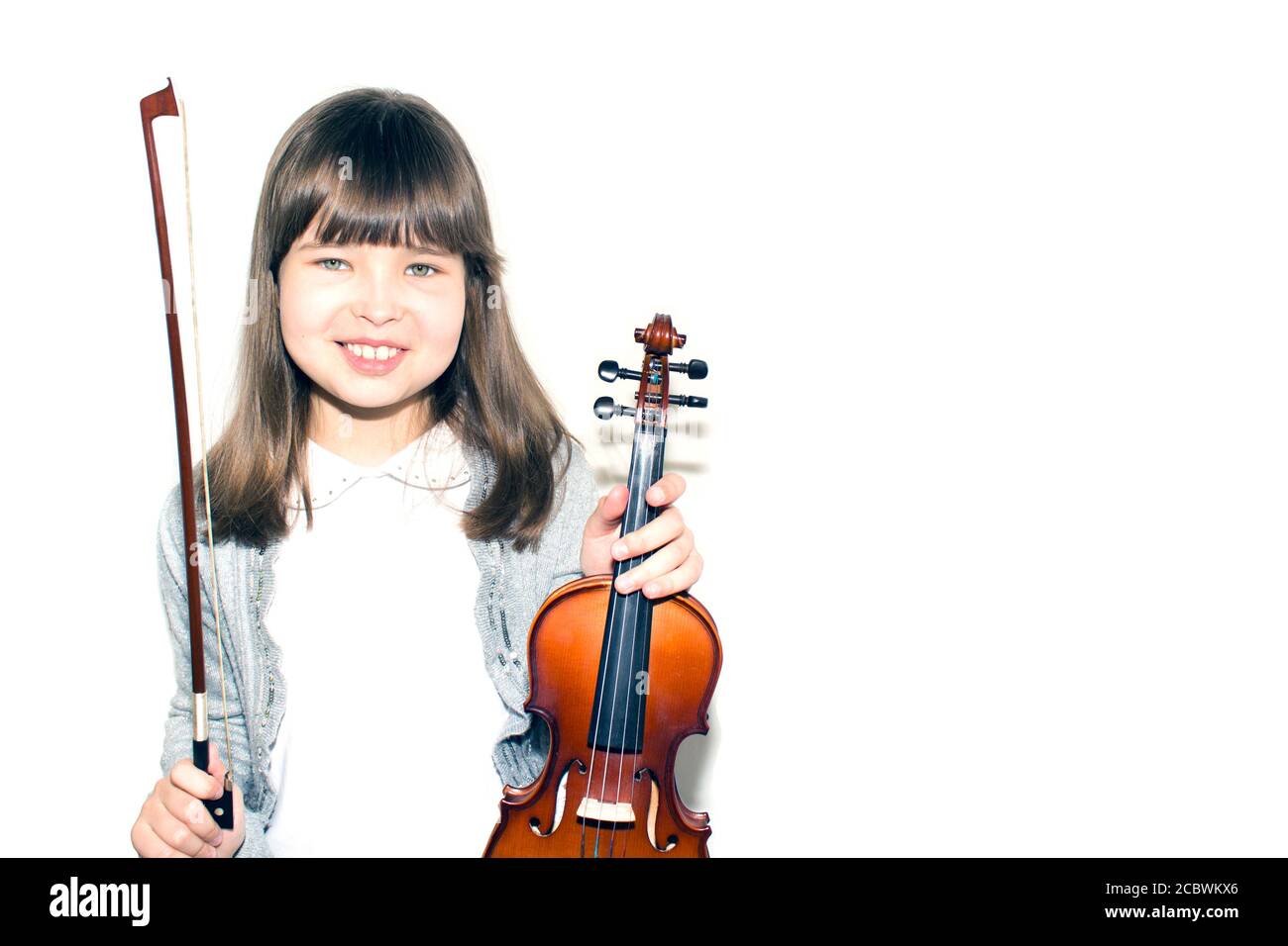 the child holds the violin and smiling Stock Photo - Alamy