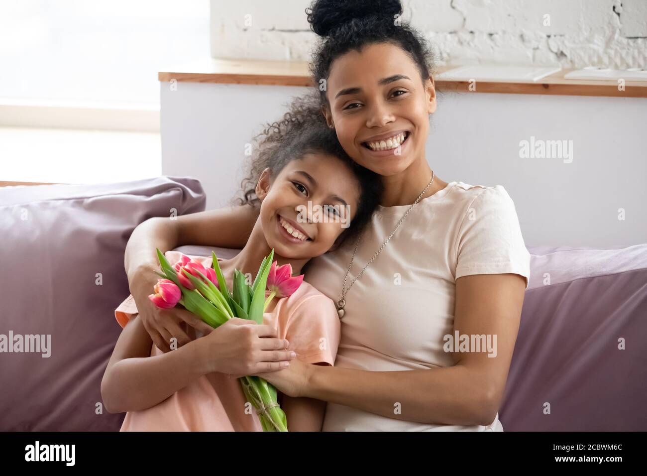 Happy african mother and daghter portrait with bunch of flowers Stock ...