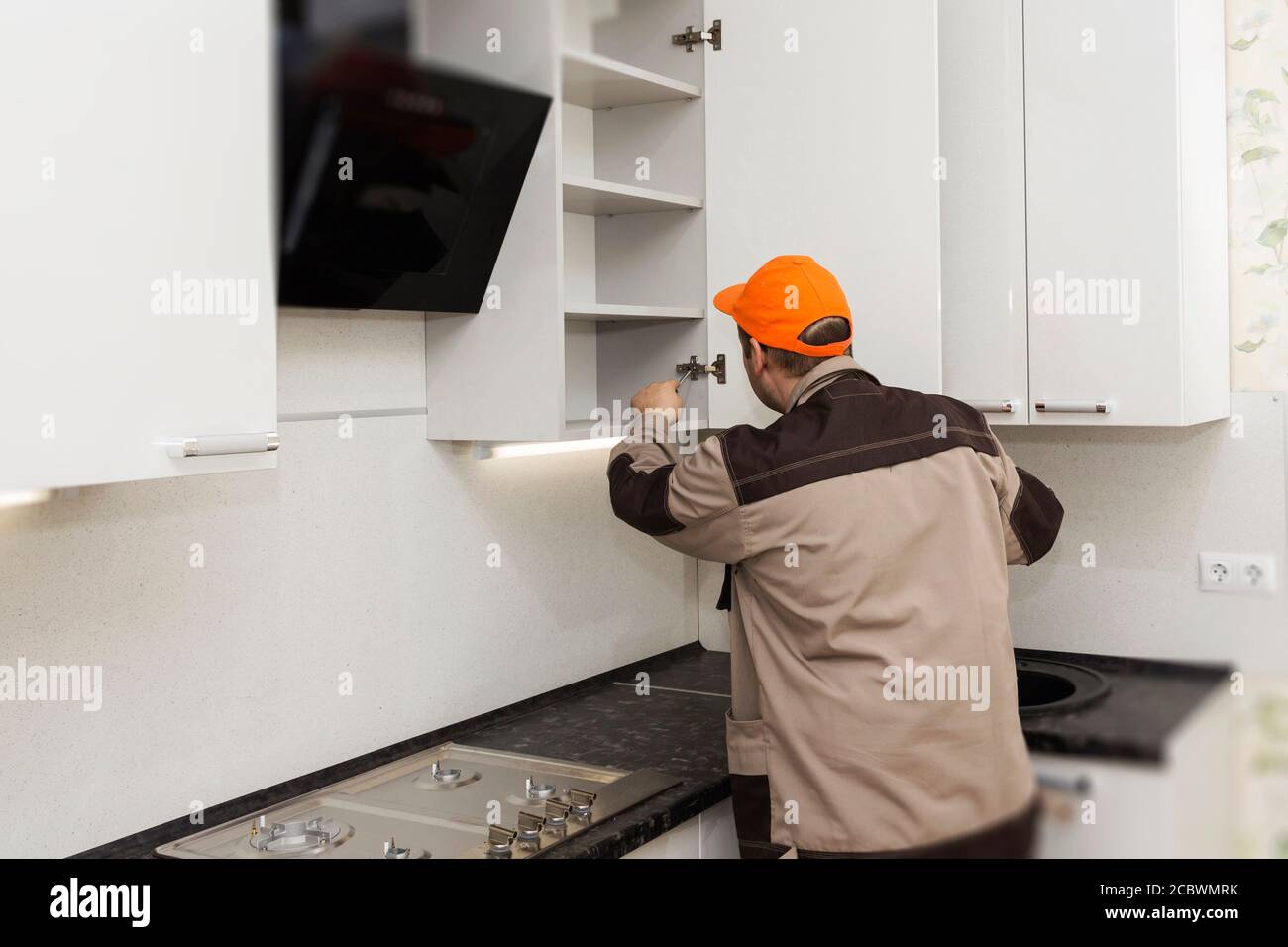 Assembly of kitchen furniture Stock Photo - Alamy