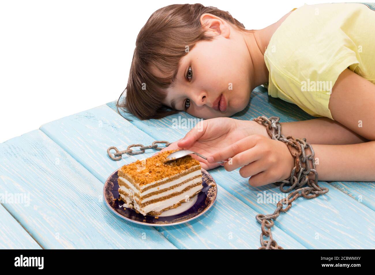 girl looking at delicious Cake on light blue background Stock Photo - Alamy