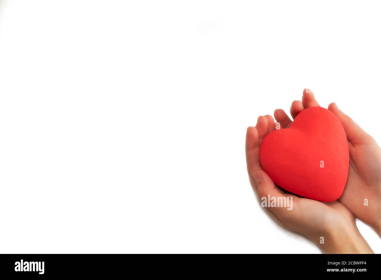 red heart in women's hands on a white background. Take care of your ...