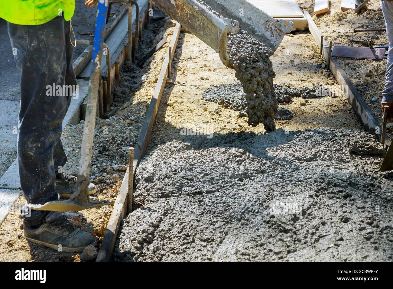 Construction worker pour cement for sidewalk in Ttuck mixer pouring ...