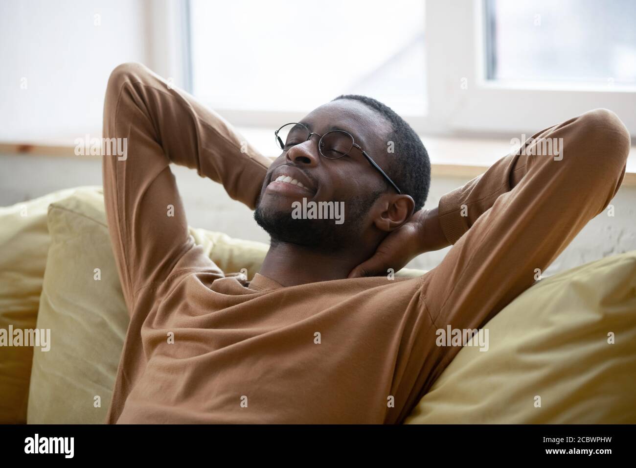African man sleeping on sofa hi-res stock photography and images - Alamy