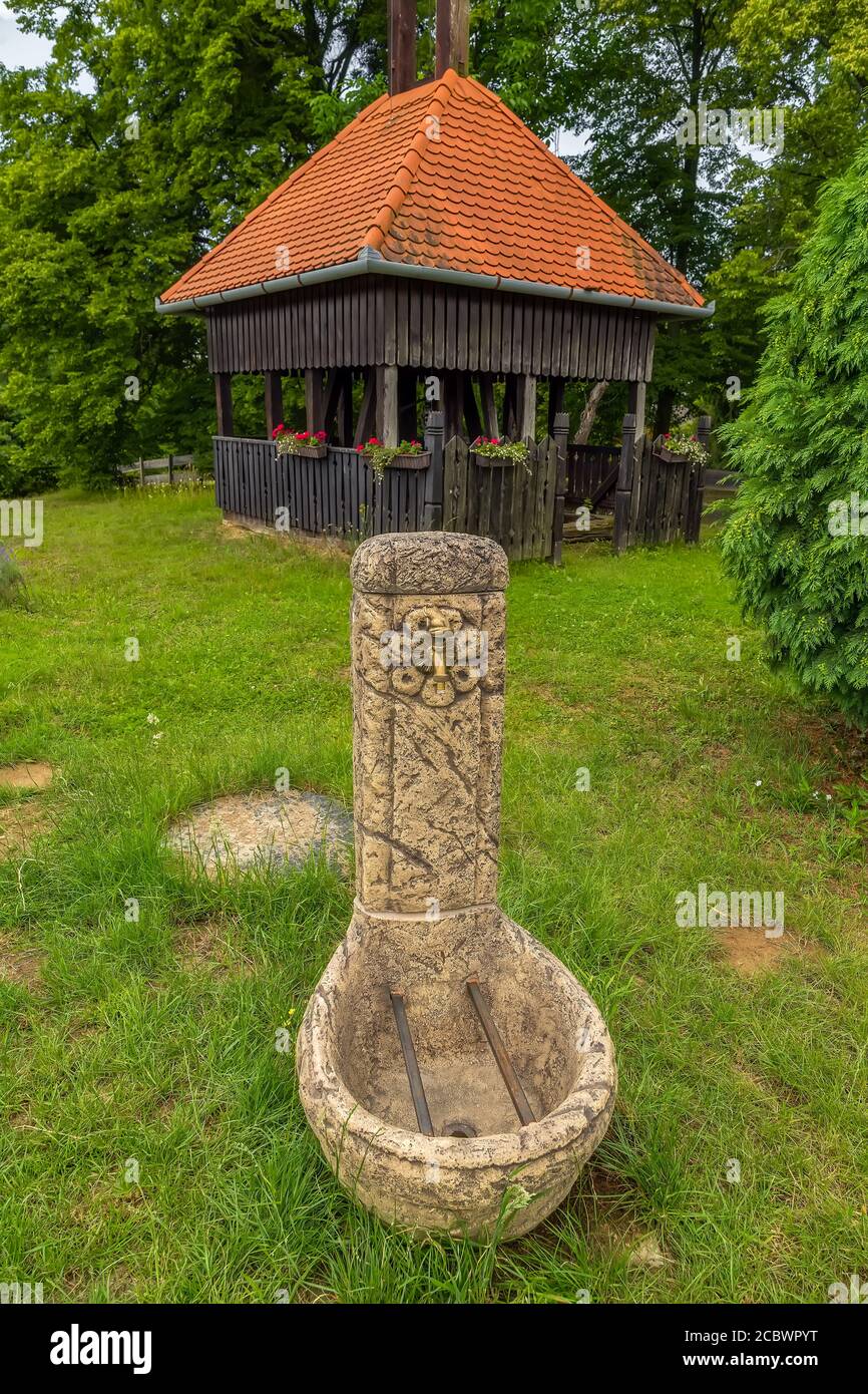 Standing stone drinking fountain with a frog-shaped tap Stock Photo - Alamy