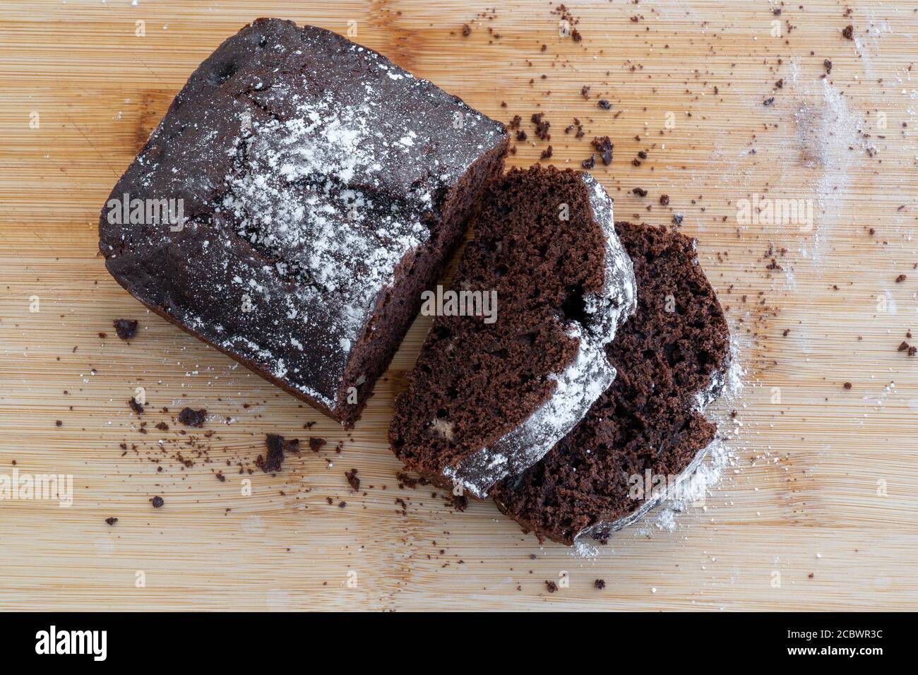 Homemade chocolate cake cut into pieces on a wooden table. Recipe of ...