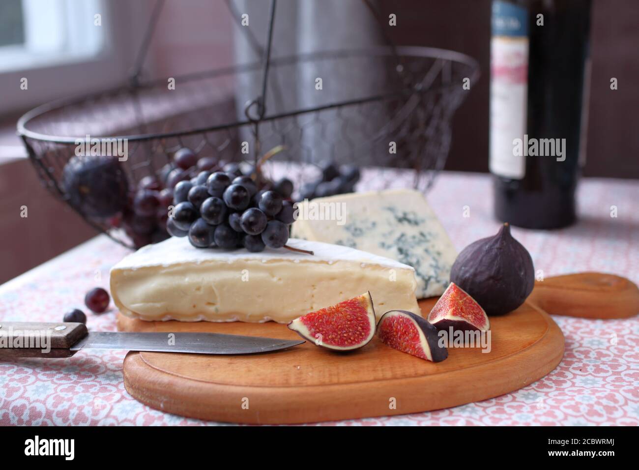 Camembert and blue cheese with figs and black grape Stock Photo - Alamy