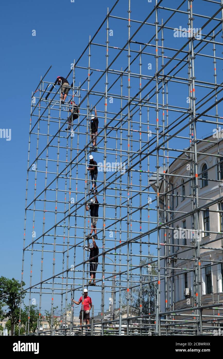 Scaffolders preparing the plinth for a large screen to broadcast a ...