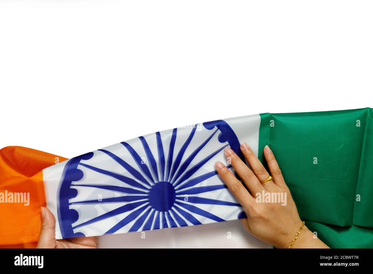 Top view of human hands holding a National Flag of India on white ...