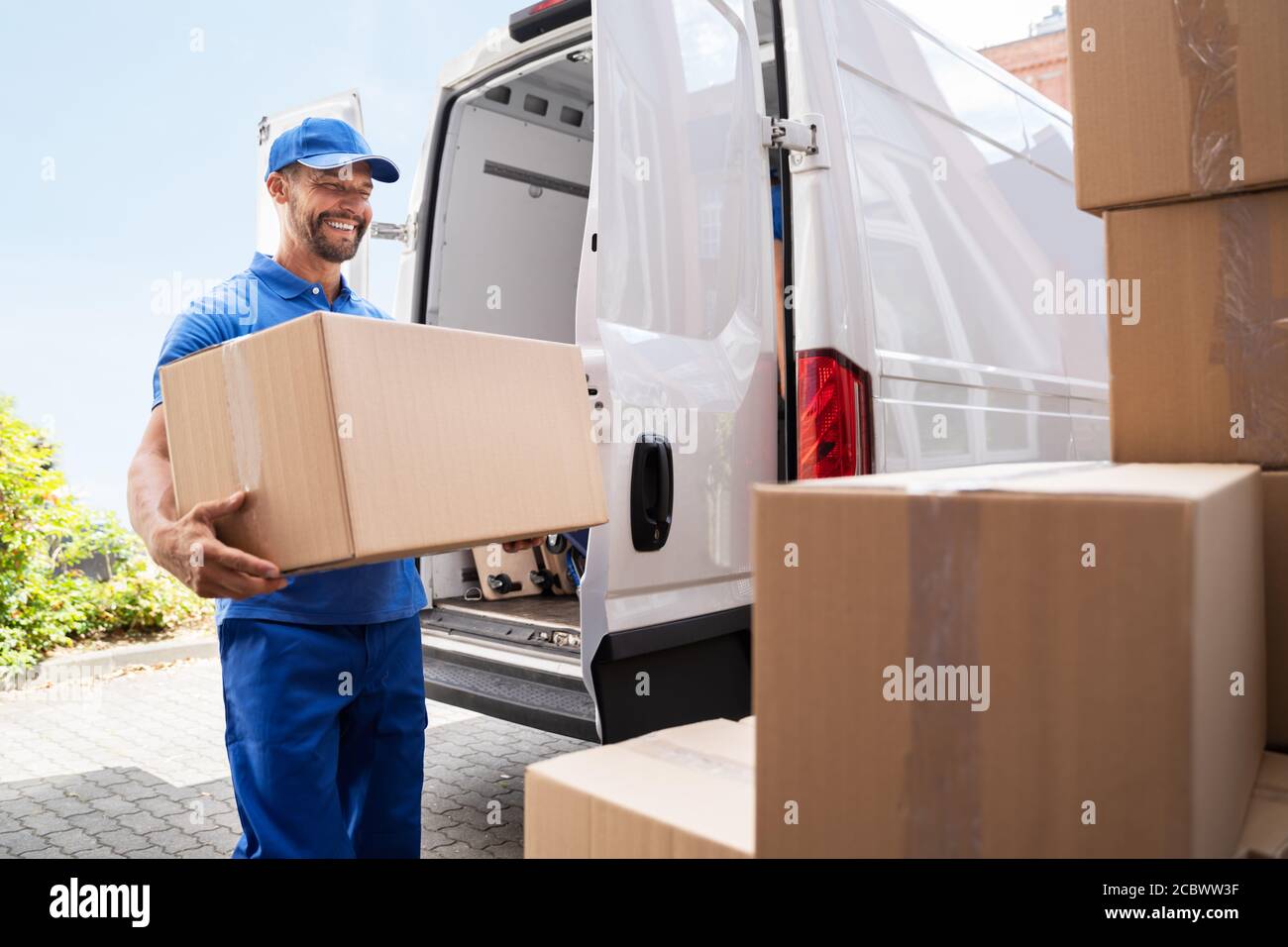 Truck Mover Unloading Van Carrying Boxes And Moving House Stock Photo ...