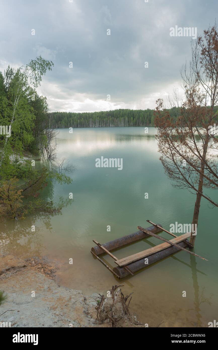 Raft On The green lake near the shore. Summer lake view. Blue sky and ...