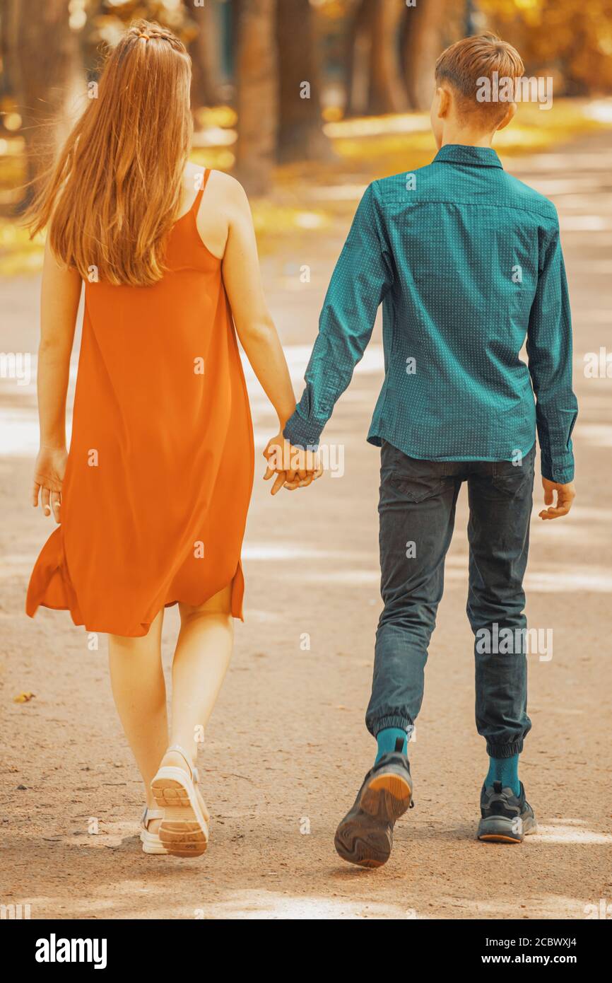 young couple walks in the park. back view Stock Photo - Alamy