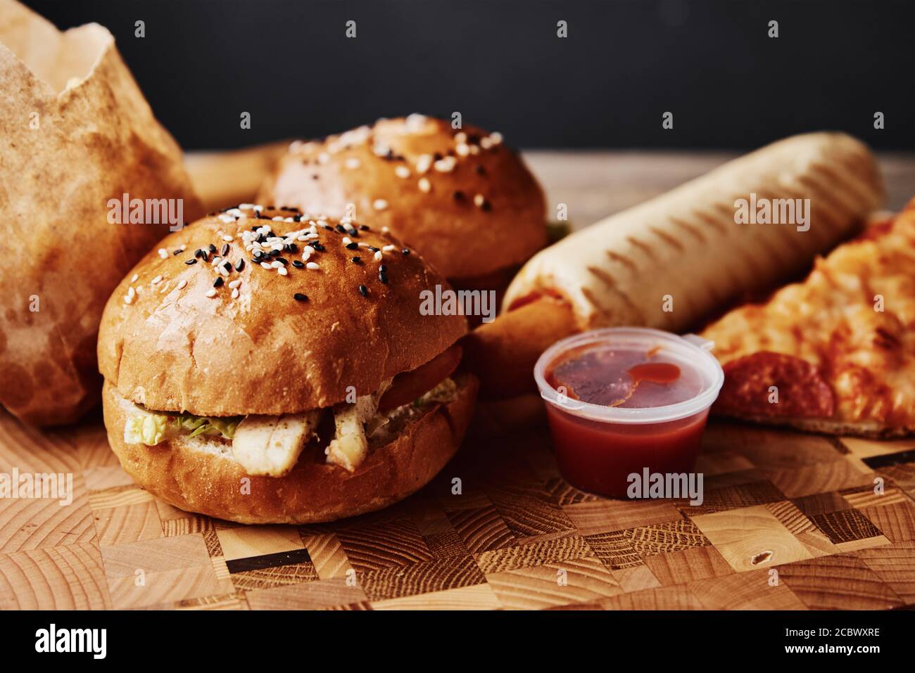 Unhealthy and junk food on dark background. Different types of fastfood ...