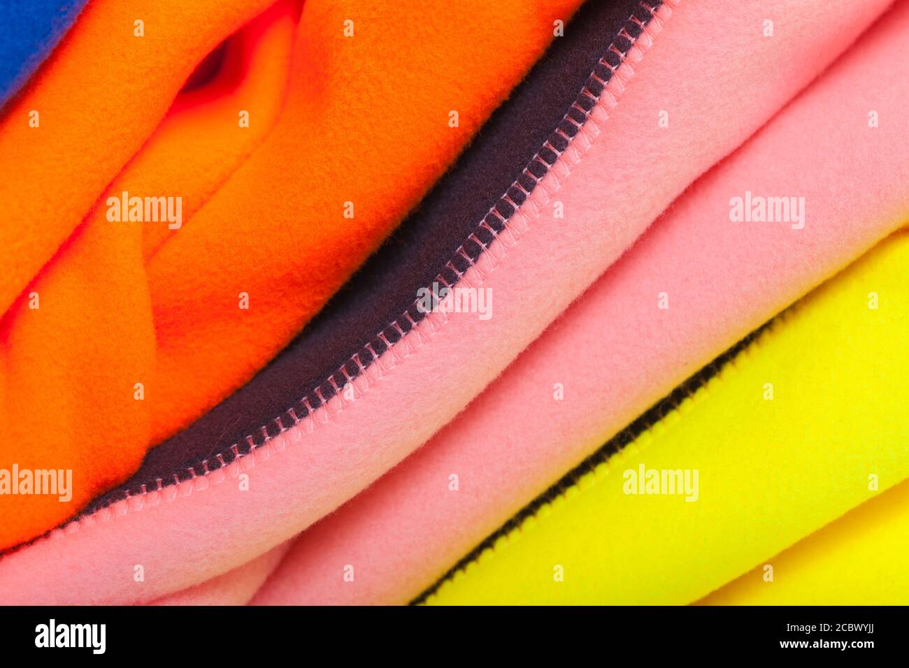 Pile of colorful fleece clothes with seams, close up photo Stock Photo ...