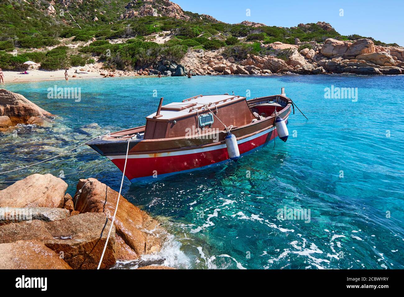 Isola Spargi island, boat floating on cyan immaculate clear water of ...