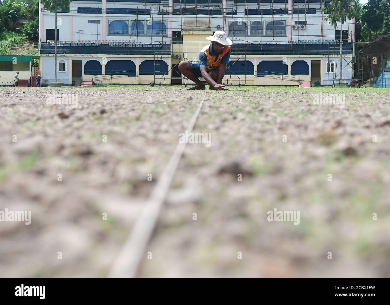 The ground staff of Tripura Cricket Association (TCA) are cleaning and ...