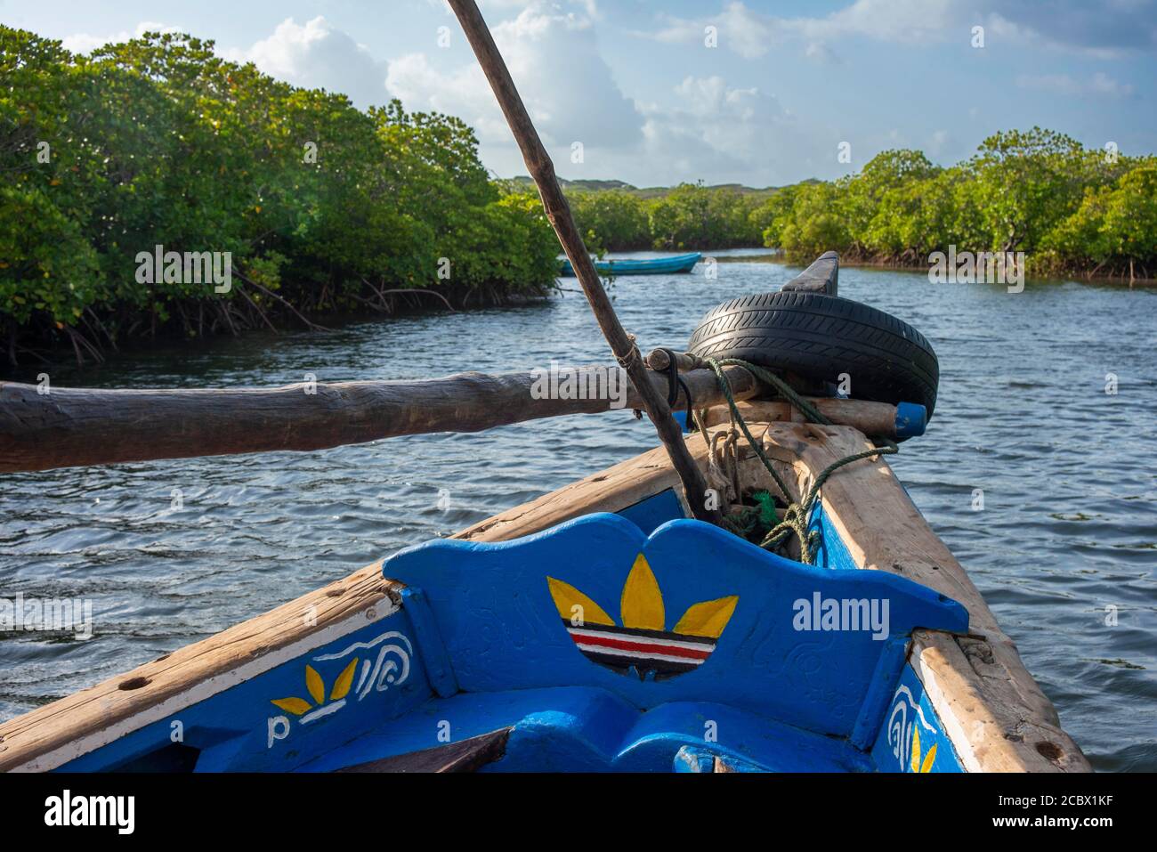 Dhow sailing through Makanda Channel, Lamu archipelago, Kenya. Red ...