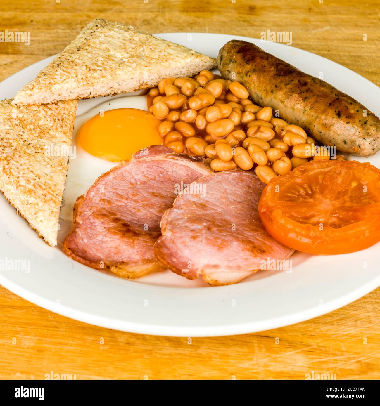 Traditional Fried English Breakfast With Egg Bacon Sausage Tomato and ...