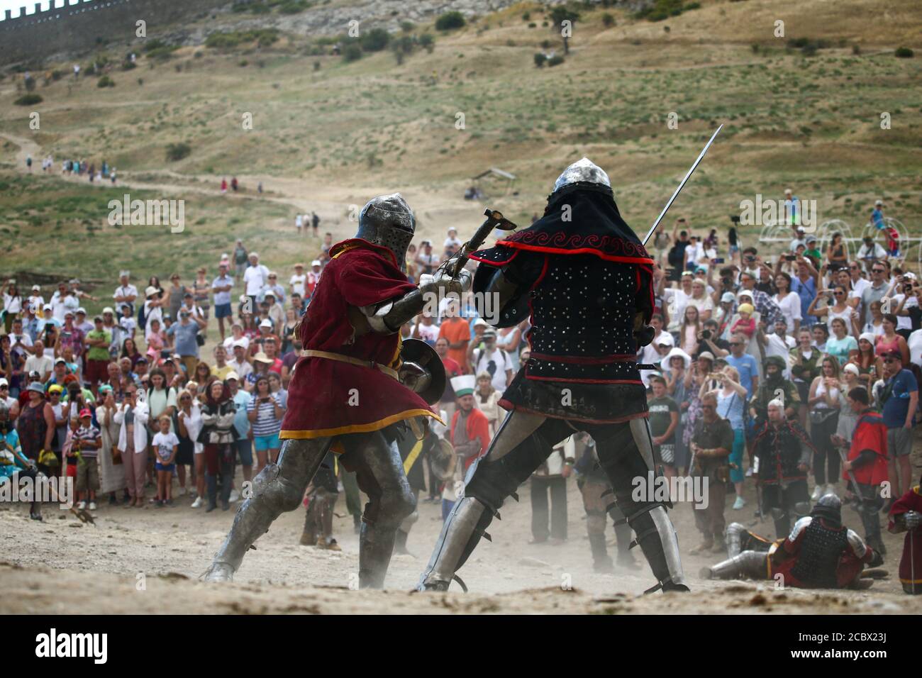 Crimea, Russia. 16th Aug, 2020. Men in armour engage in a sword fight ...